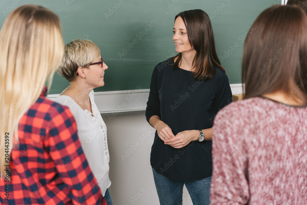 Group of women standing having a discussion Stock-Foto | Adobe Stock