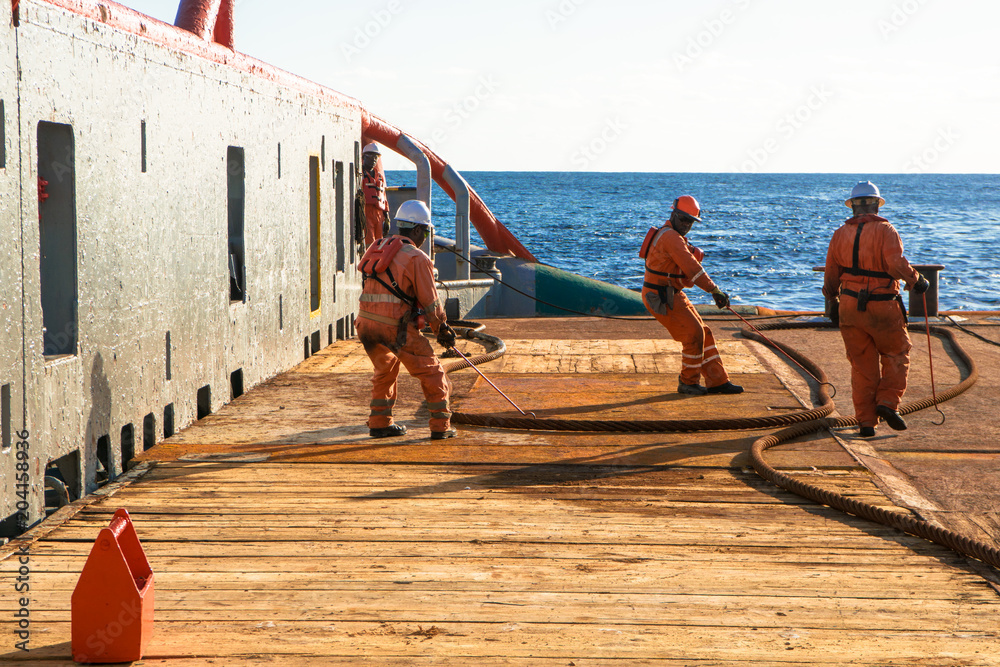 Anchor-handling Tug Supply AHTS vessel crew preparing vessel for static ...