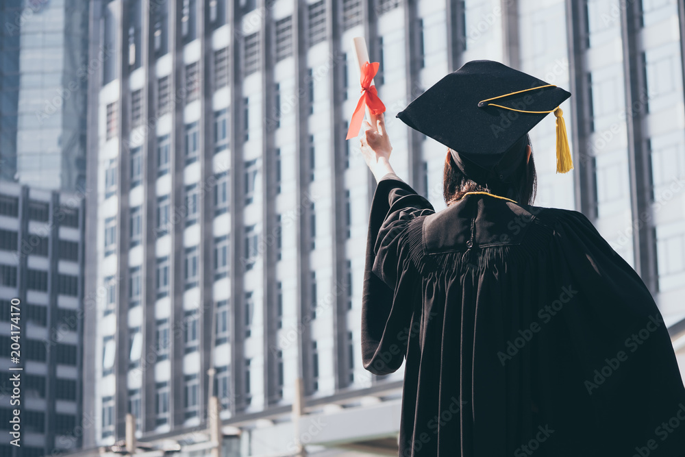 Graduation day, Back view of Asian woman with graduation cap and gown ...