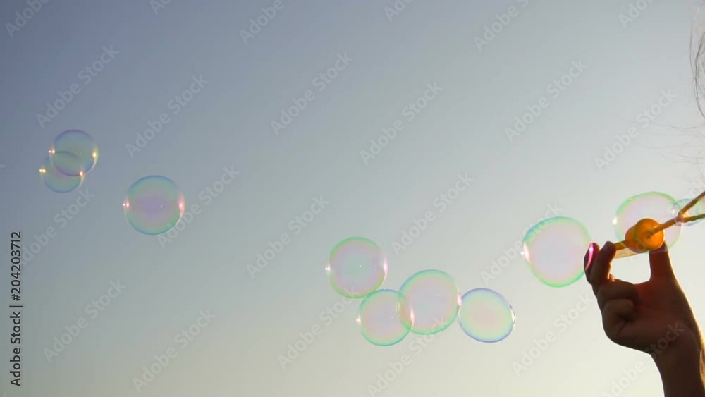 Blowing bubbles against the sky Stock Video | Adobe Stock