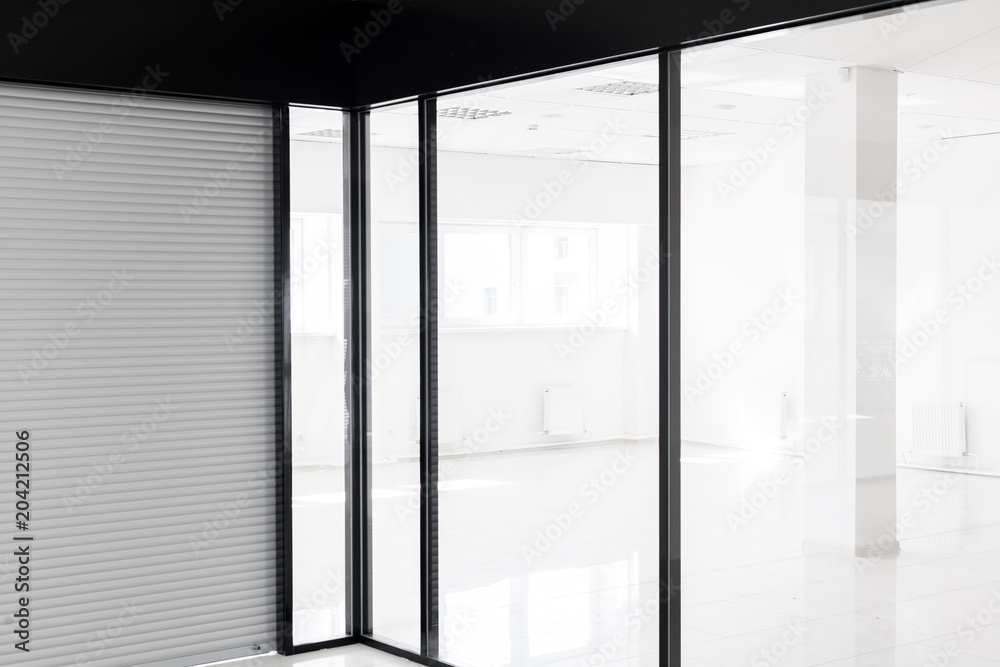 White clean empty well-lit shopping area with windows, glass showcases ...