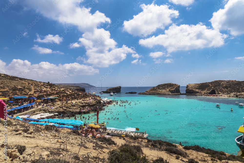 Comino Island, Malta Blue Lagoon panoramic landscape with bathers. The ...