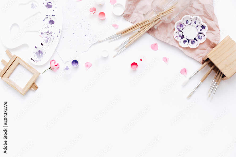 Flat lay art workspace, sheet of paper with paints and brushes on white ...