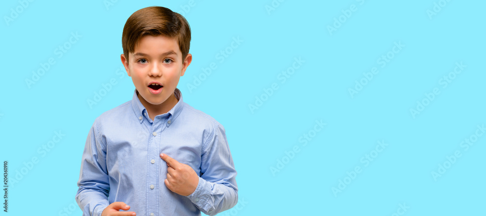 Handsome toddler child with green eyes happy and surprised cheering ...