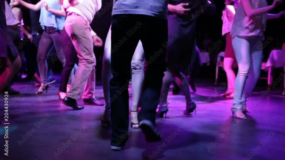 The feet of the boy and girl in the dance. Party, night, fast music ...