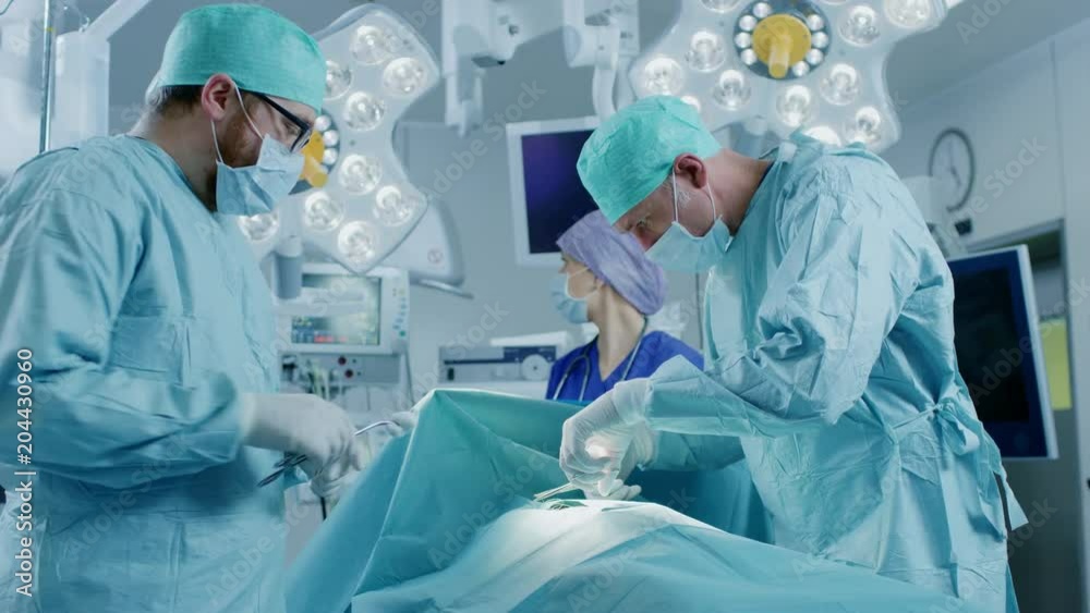 In the Hospital Operating Room Diverse Team of Professional Surgeons ...