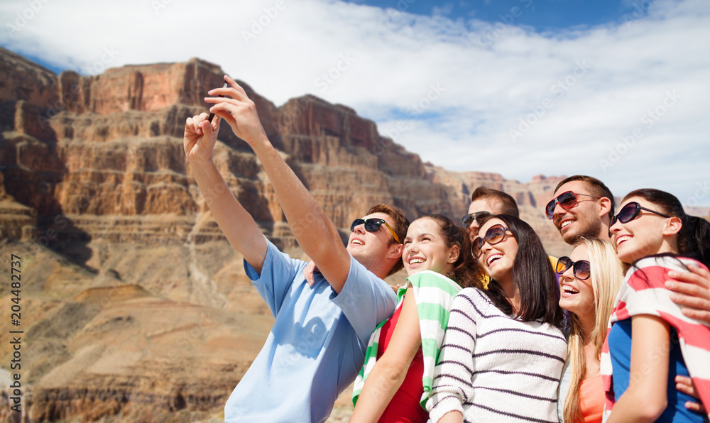 travel and tourism concept - group of happy friends taking selfie by ...