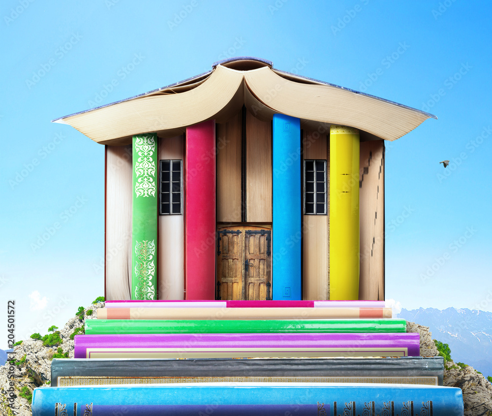 Education concept. Stack of books in form of a building on a sky background. Ancient temple ...