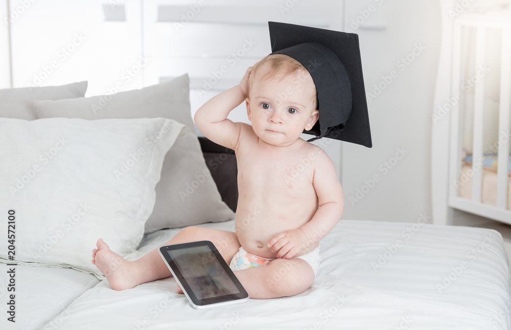 Funny image of adorable baby boy in diapers and graduation hat sitting ...