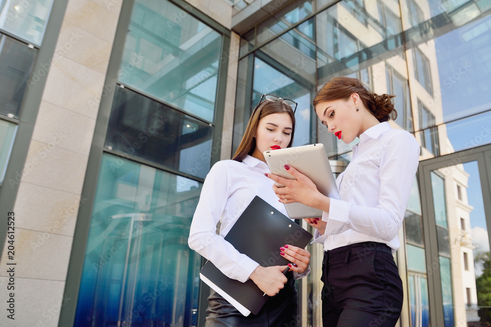 Business lady. Office staff. Two young girls with electronic tablets ...