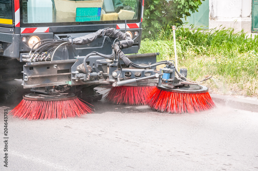 Street sweeper vehicle washing walkway and road with water and cleaning ...