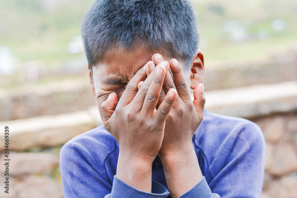 Native american kid crying and closing his face with hands. Stock Photo ...