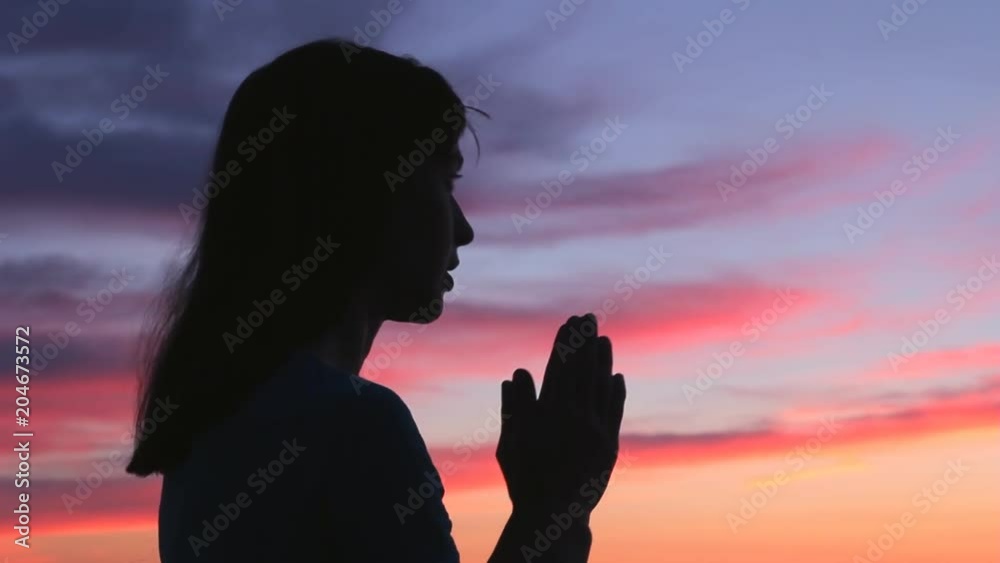 Praying girl silhouette colorful sunset. Woman with gratitude pray ...