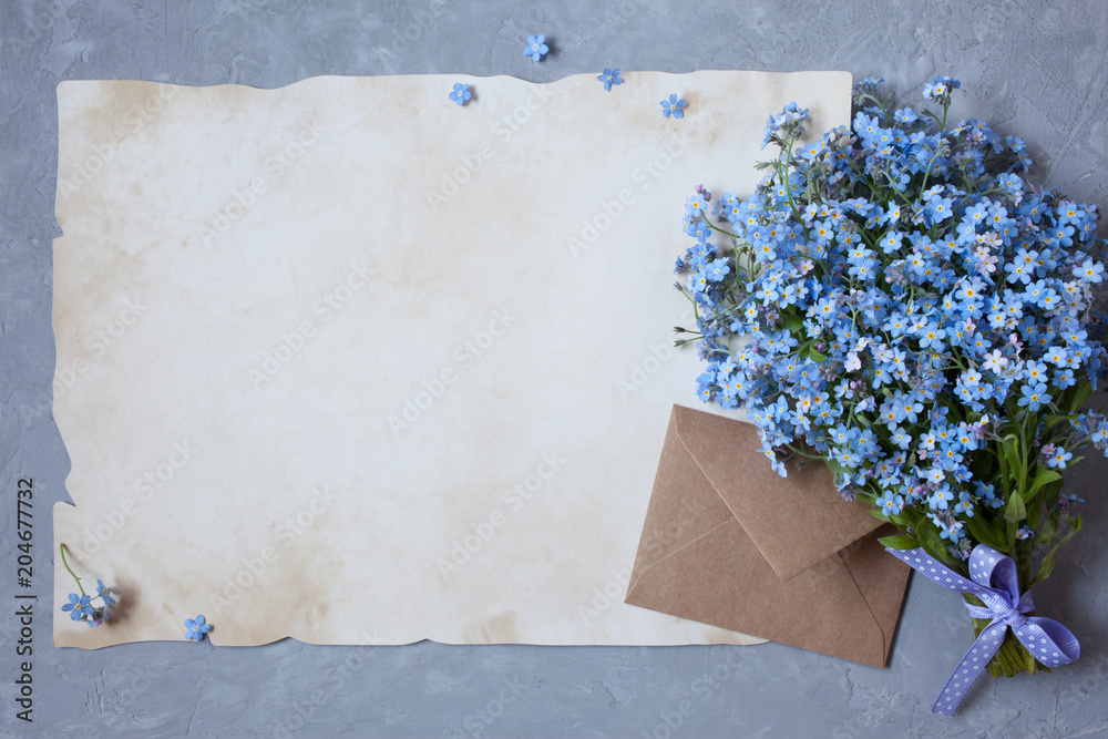 Bouquet of forget-me-nots and congratulatory paper, letters, envelope ...