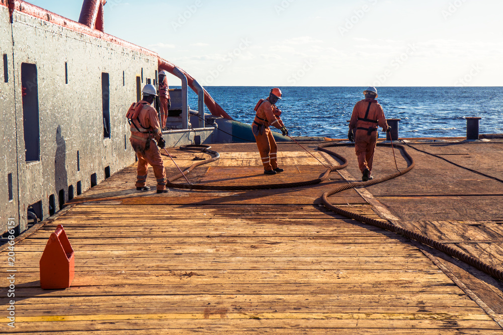 Anchor-handling Tug Supply AHTS vessel crew preparing vessel for static ...