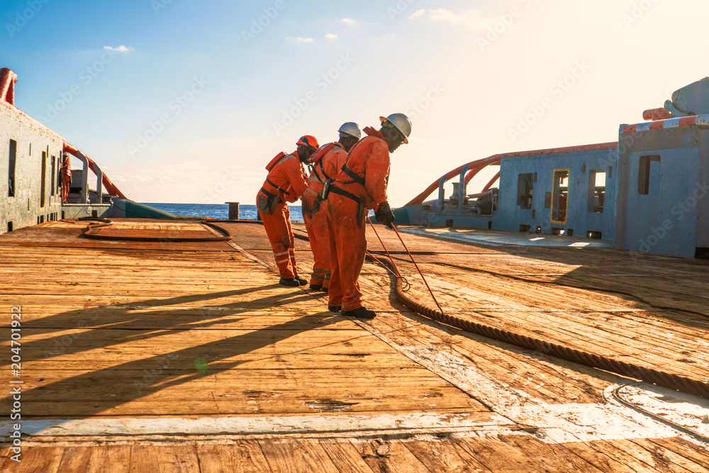 Anchor-handling Tug Supply AHTS vessel crew preparing vessel for static ...