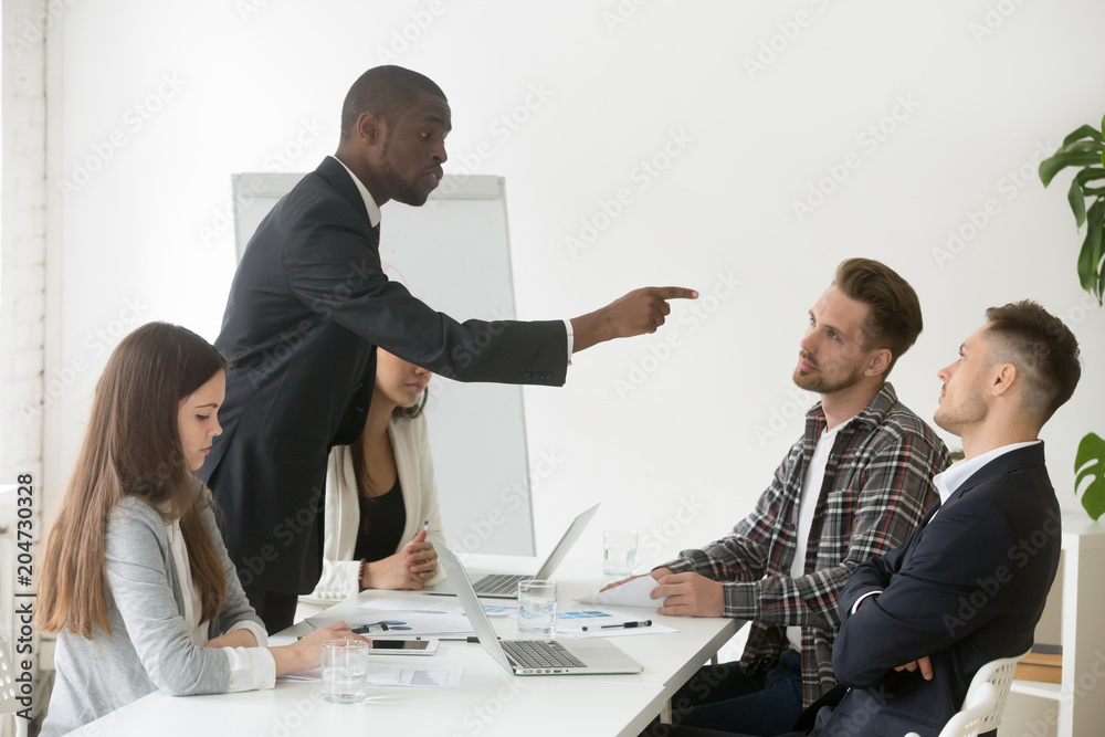 Angry rude african businessman pointing finger threatens caucasian ...