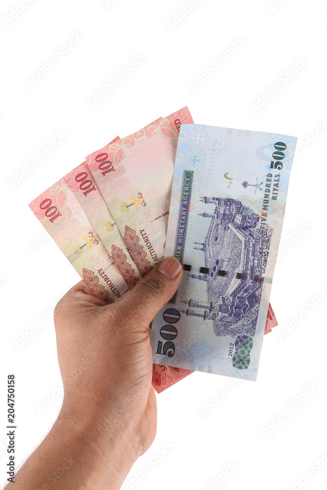 Saudi man counting thousands Saudi Riyal isolated on white background ...