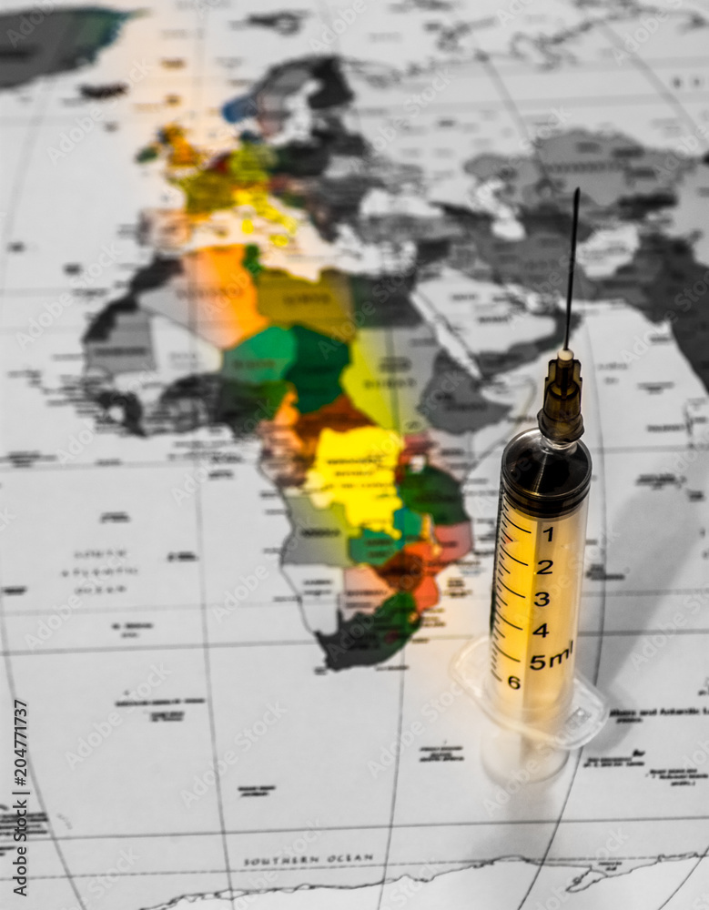 A single syringe with a needle is on the political map of the world ...