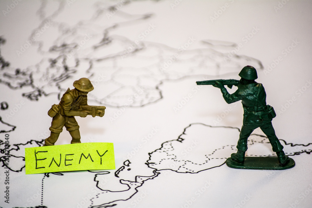 Plastic toy soldiers are on the world map. Stand opposite each other ...