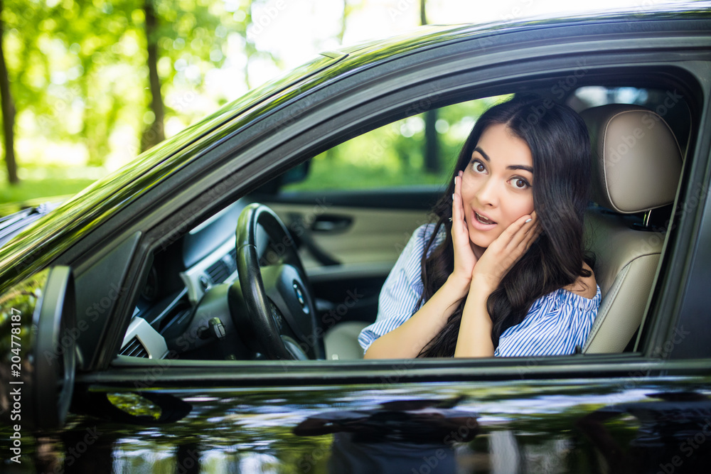 Distracted fright face of a woman driving car, wide open mouth side ...