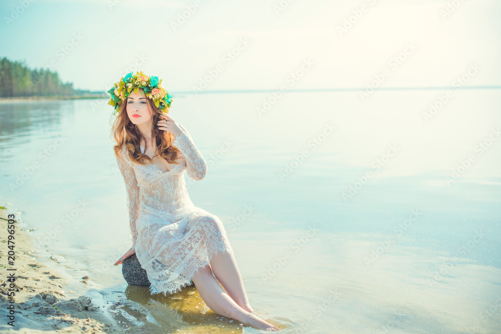 Woman in lace white dress in the water. Art Woman with wreath on her ...