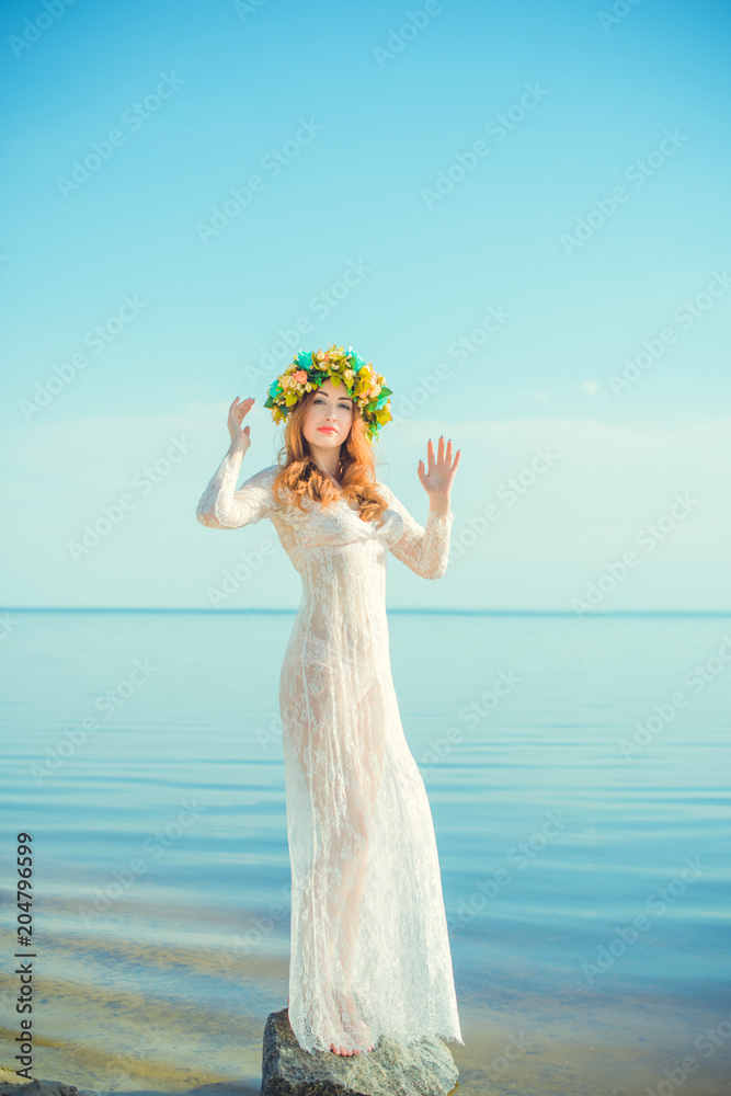 Woman in lace white dress in the water. Art Woman with wreath on her ...