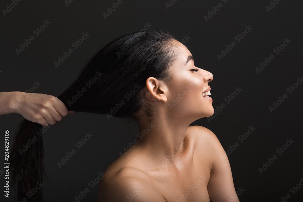 Profile of nude woman being positive. Someone pulling her by hair ...