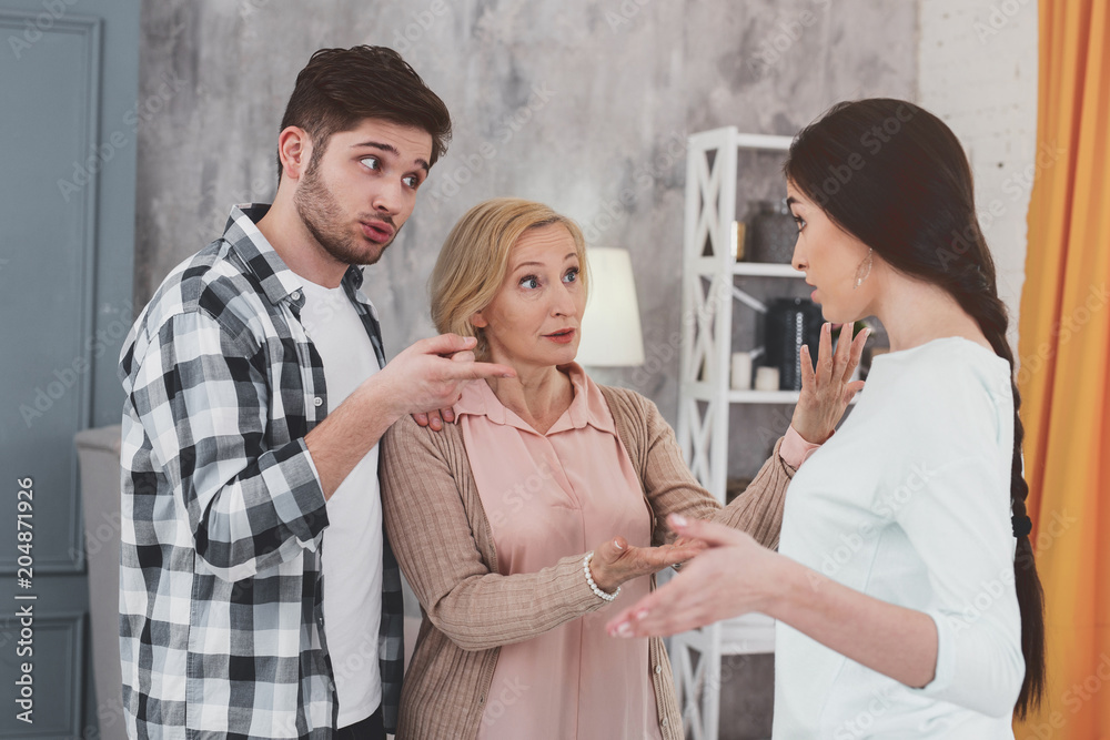 Relationships problems. Cheerless young people looking at each other ...