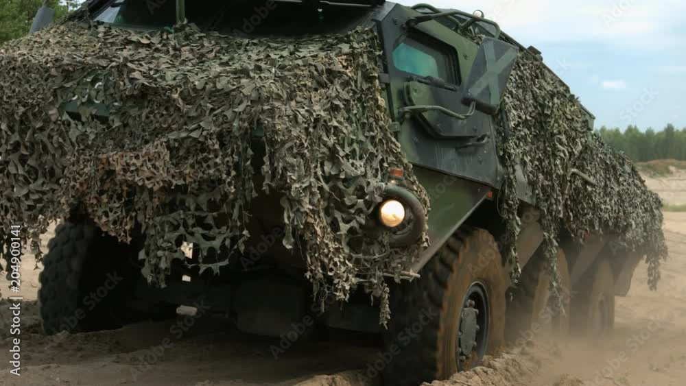 Armored military vehicle 8x8 wheeled BTR driving offroad in sand desert ...