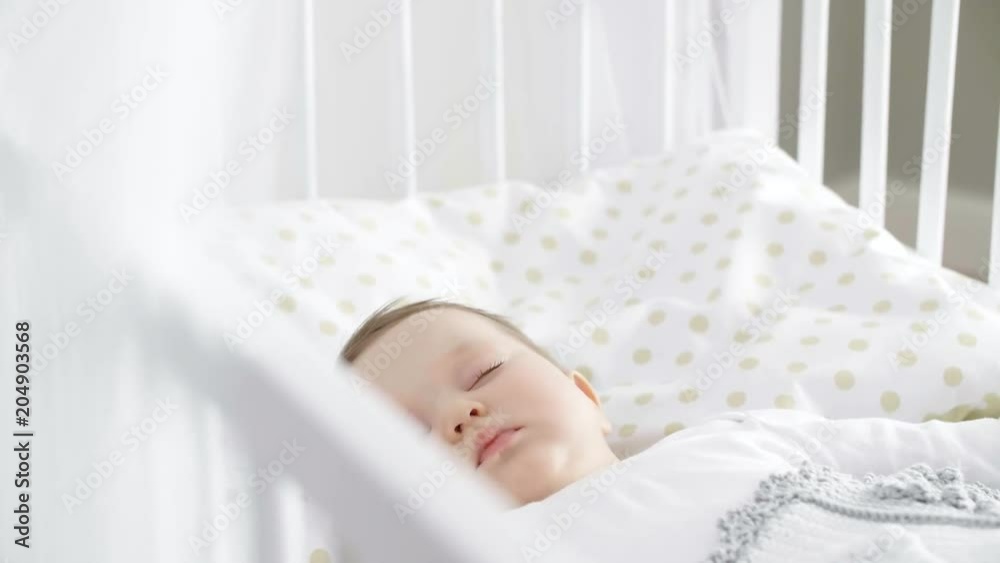 Cute baby girl sleeping in the crib Stock ビデオ | Adobe Stock