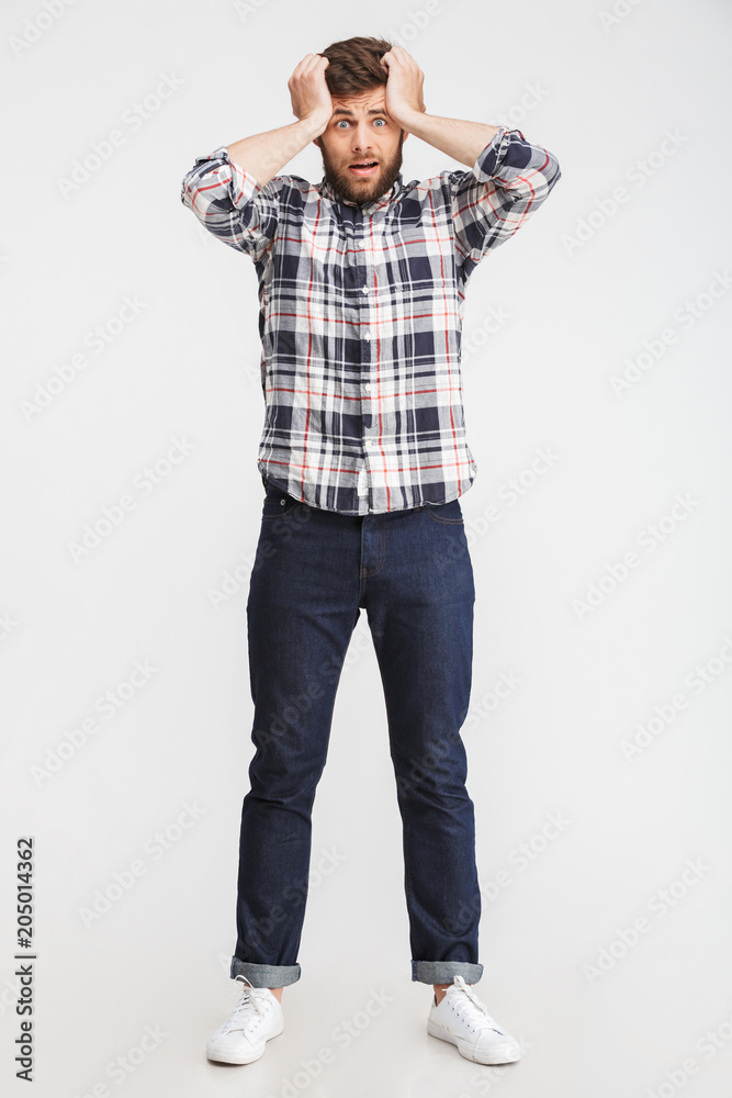 Full length portrait of a shocked young man Stock Photo | Adobe Stock