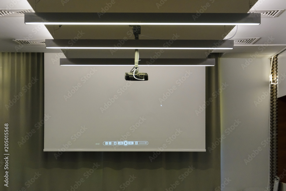Projector in a room with projector screen on back ground. Stock Photo ...