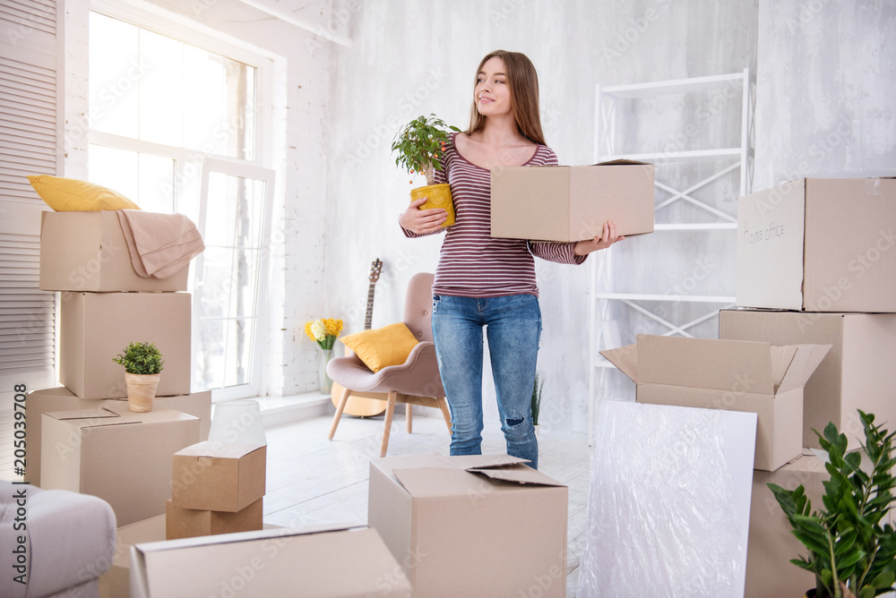 Packing spree. Beautiful young woman standing in the middle of the ...