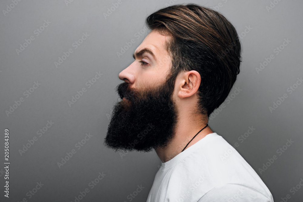 Side view of masculine Caucasian bearded male wearing casual white t ...