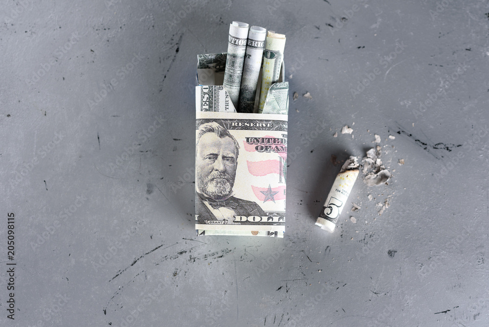 Package of cigarette filled with paper money dollars banknote and ...