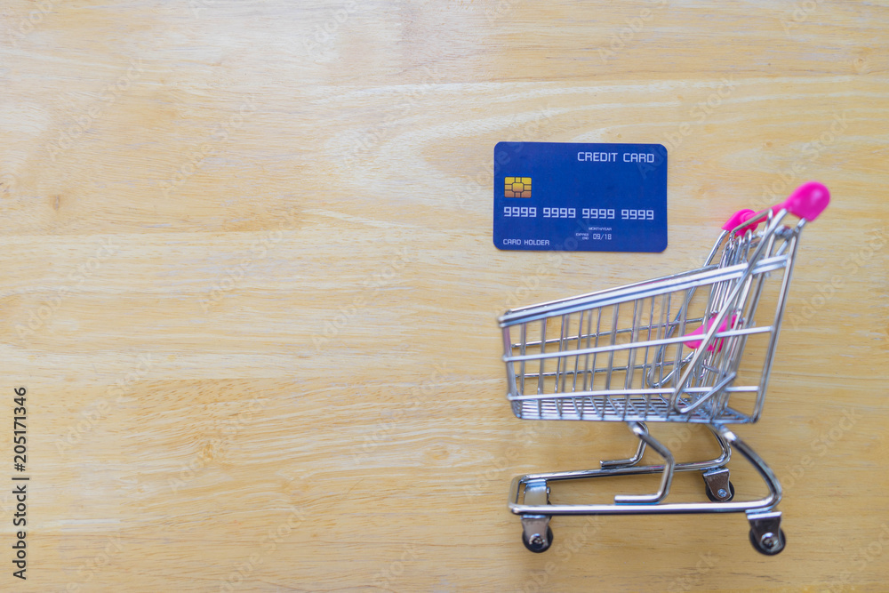 Credit card and shopping cart on wooden table. online shopping, online ...