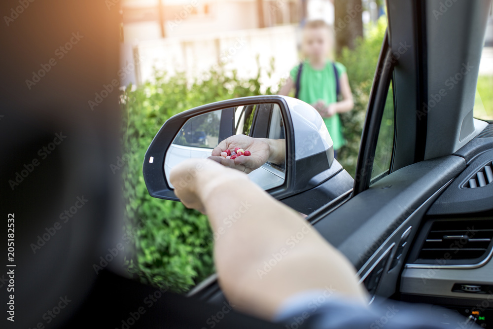 Girl is approached by a strange man in the car and attracted with candy ...