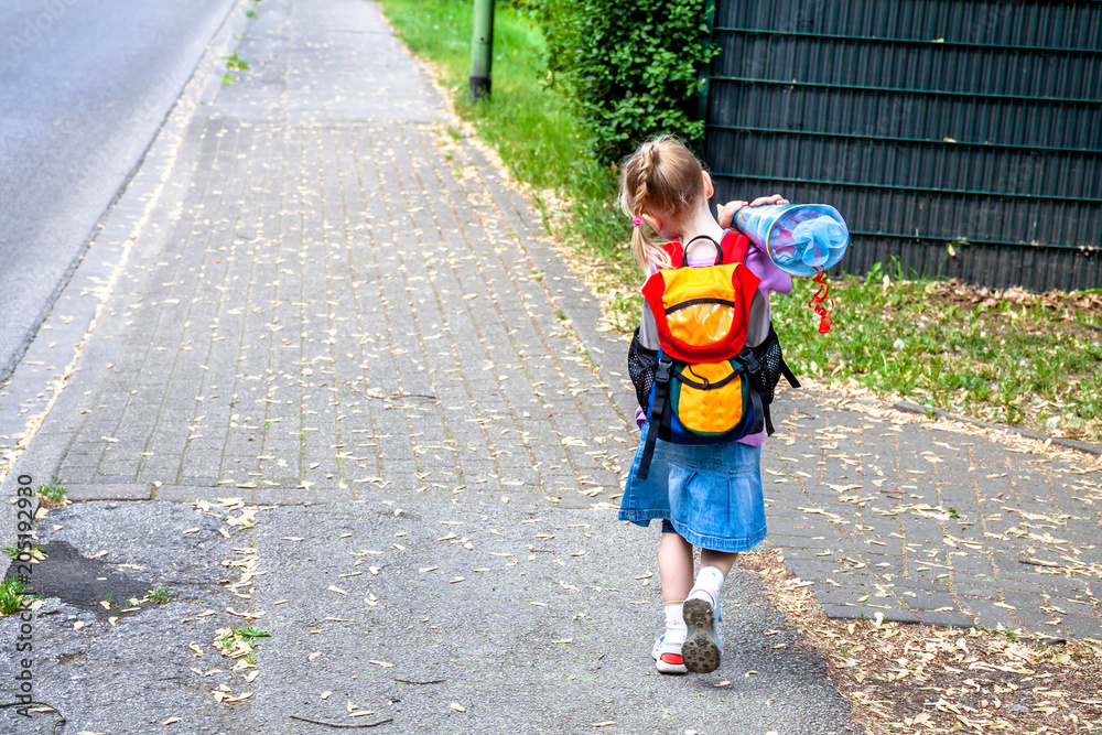 Little girl on her way to her first day of school Stock Photo | Adobe Stock