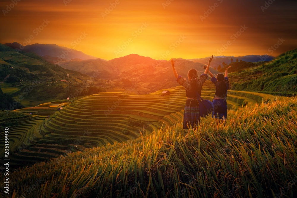 Vietnamese Hmong children raising arm on Rice fields terraced at sunset ...