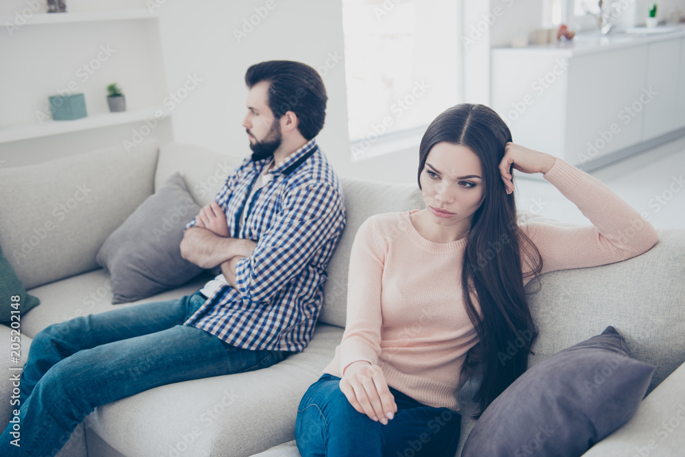 Portrait of sad couple having conflict sad man sitting with crossed ...