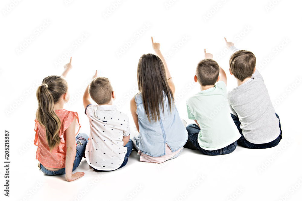 Back view of child group sitting on floor looking at wall Stock Photo ...