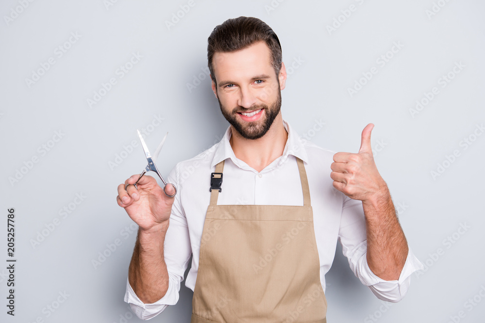 Portrait of cheerful positive barber with stubble in shirt having ...
