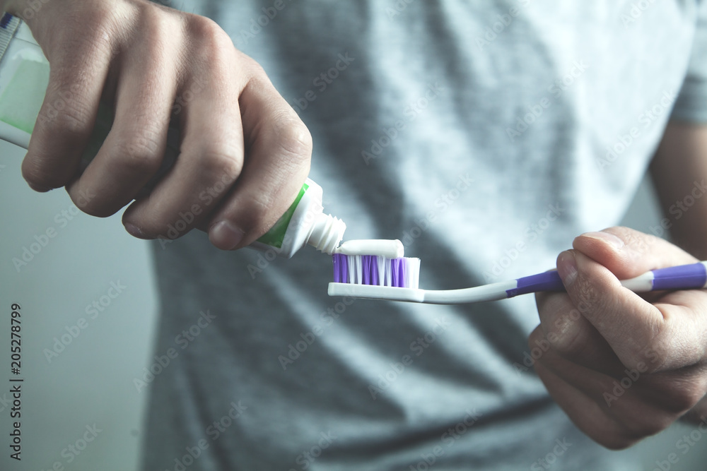 Putting Toothpaste On Toothbrush