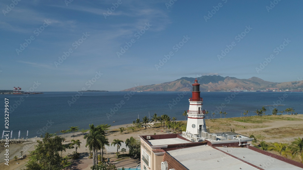 Coastline with beach and lighthouse, mountains. Aerial view: Coast sea ...