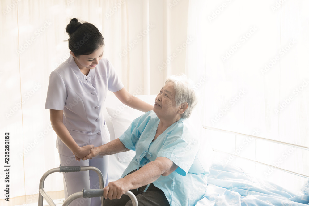 Nurse with patient. Routine health check and assisting elderly patient ...