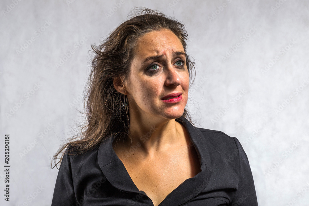 Desperate woman crying disheveled with light eyes with makeup clouded ...