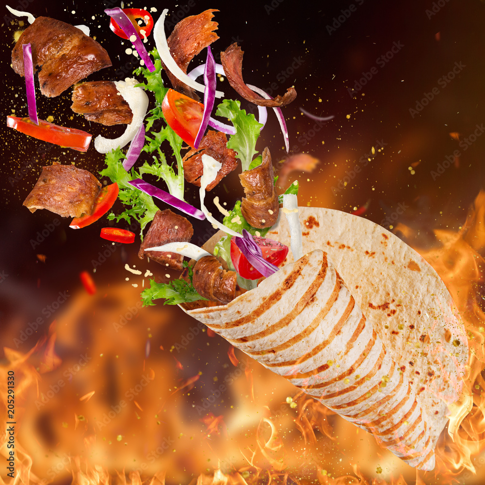 Turkish Kebab yufka with flying ingredients and flames. Stock-Foto ...