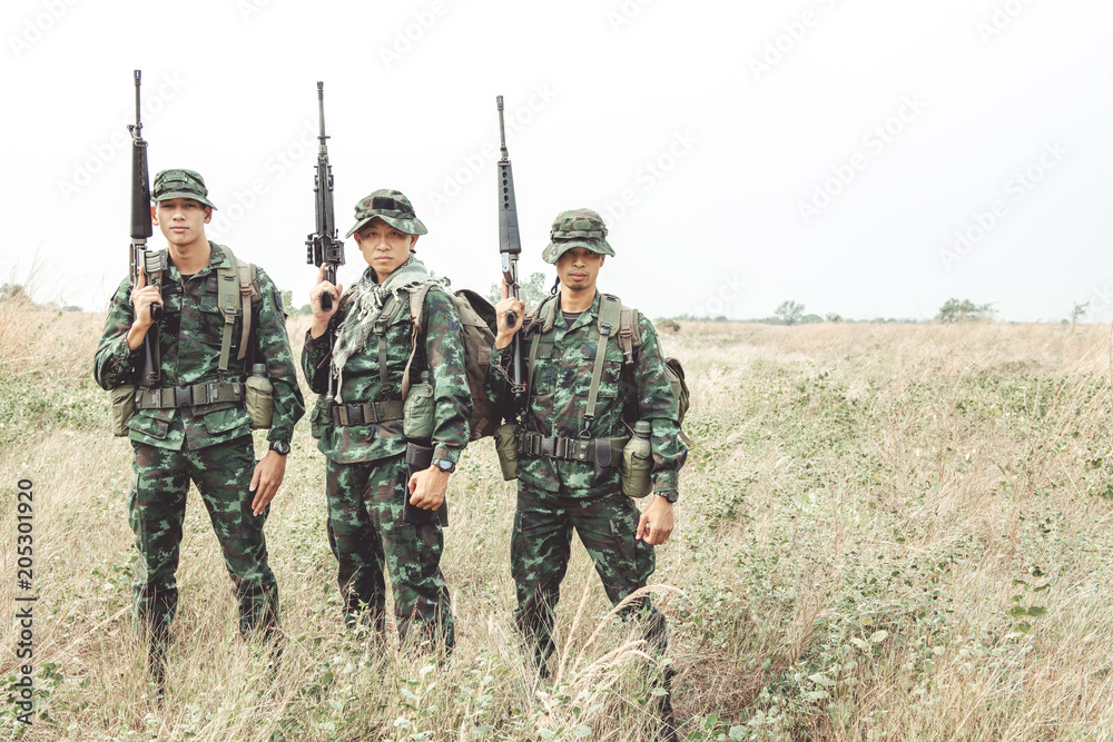 Soldier ready his weapon. Standing up holding their assault rifle ...