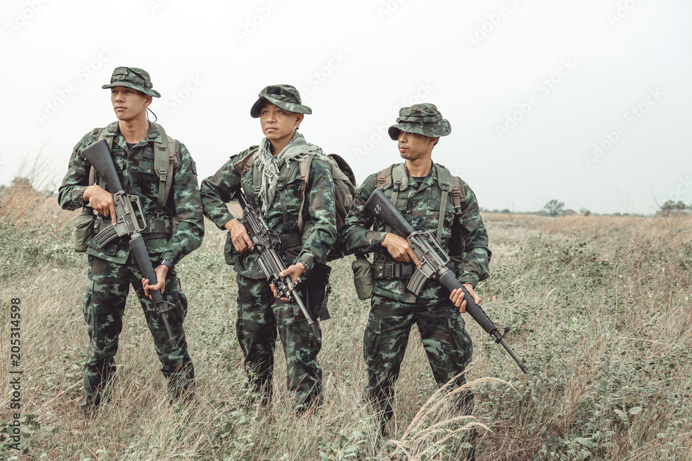 Soldier ready his weapon. Standing up holding their assault rifle ...